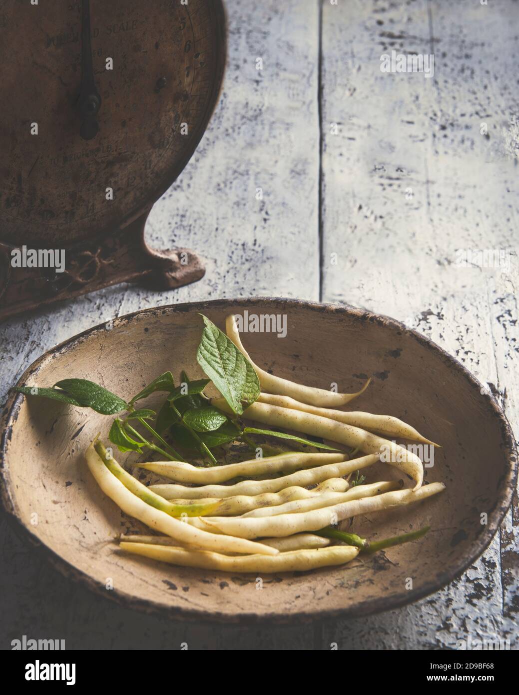 High angle of fresh green beans on plate placed on wooden table in ...
