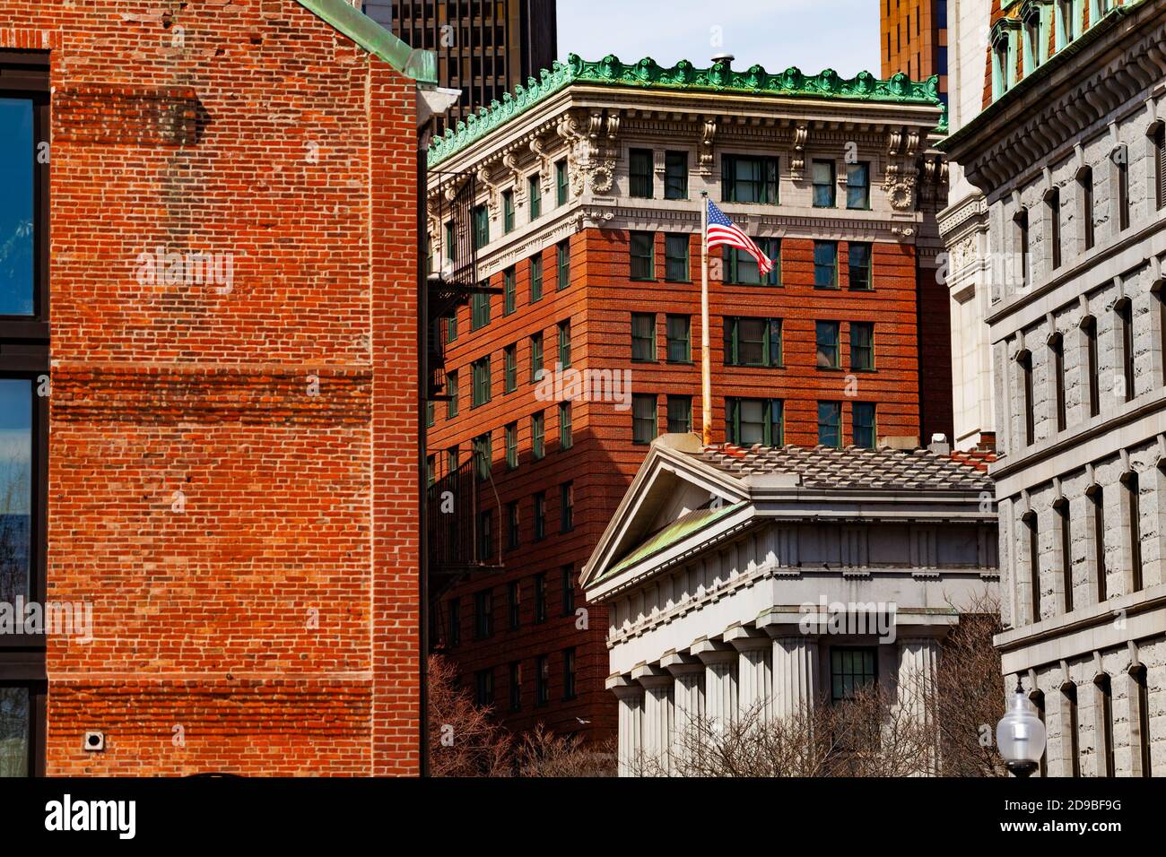 American flag on top of central street building in Boston downtown ...