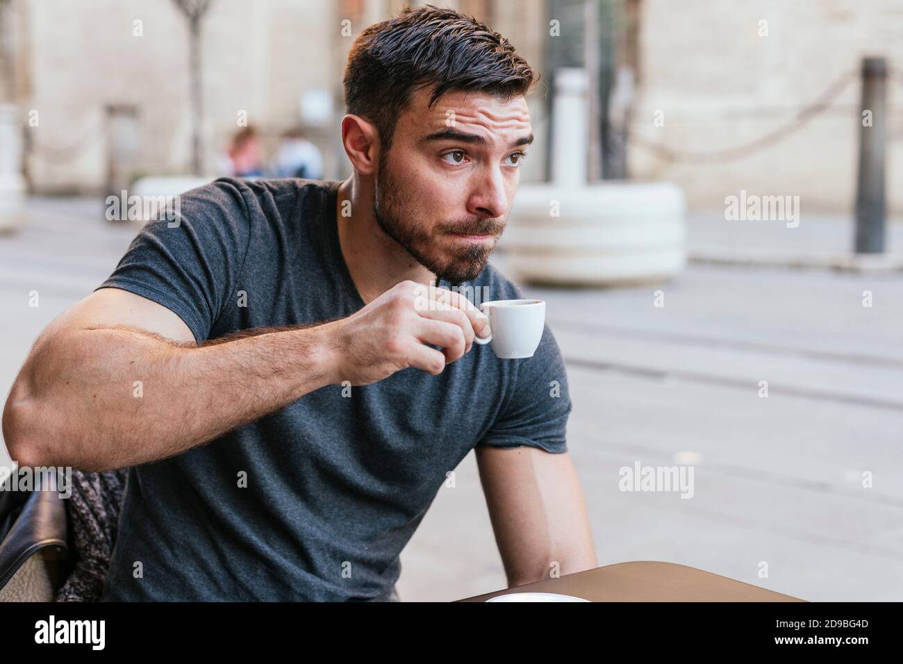 White man sitting in a cafeteria drinking coffee Stock Photo - Alamy