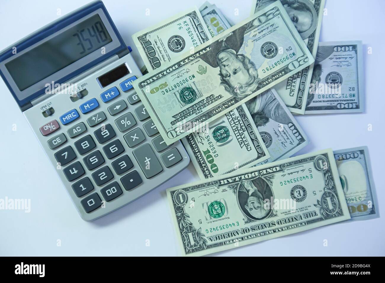 Dollar notes and calculator in office on white background Stock Photo ...