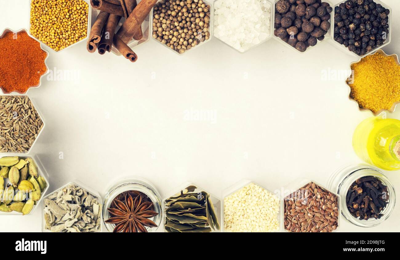 Various spices in hexagonal jars on a white background Stock Photo - Alamy