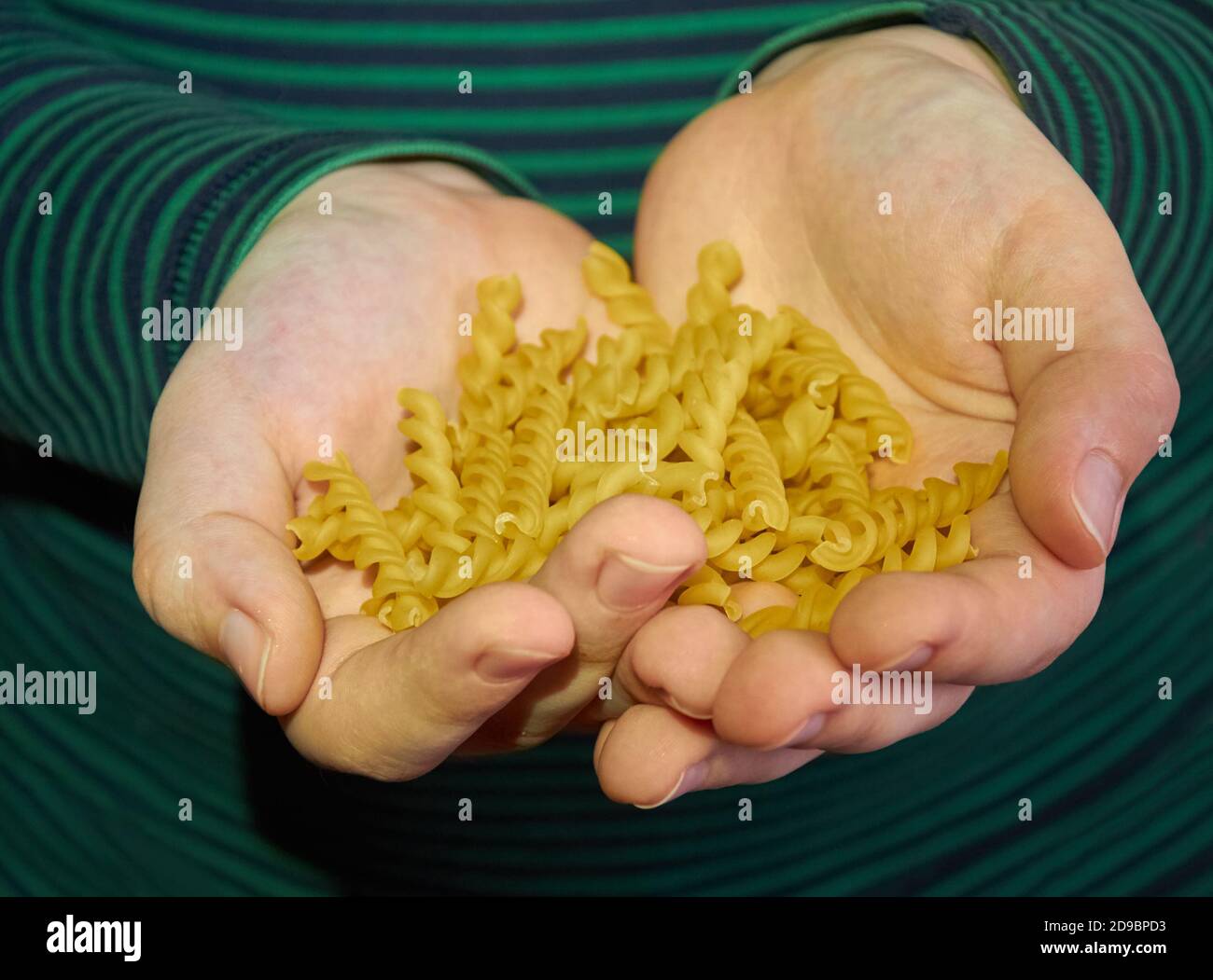 A child is holding a handful of hasta. Close up. Details Stock Photo ...