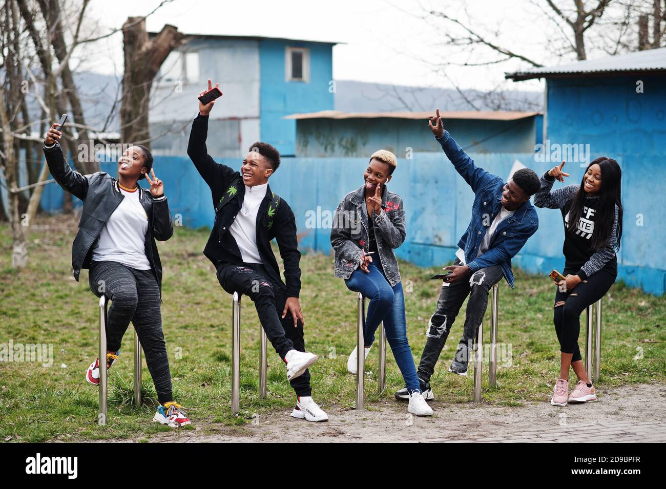 Young millennials african friends with mobile phones. Happy black ...