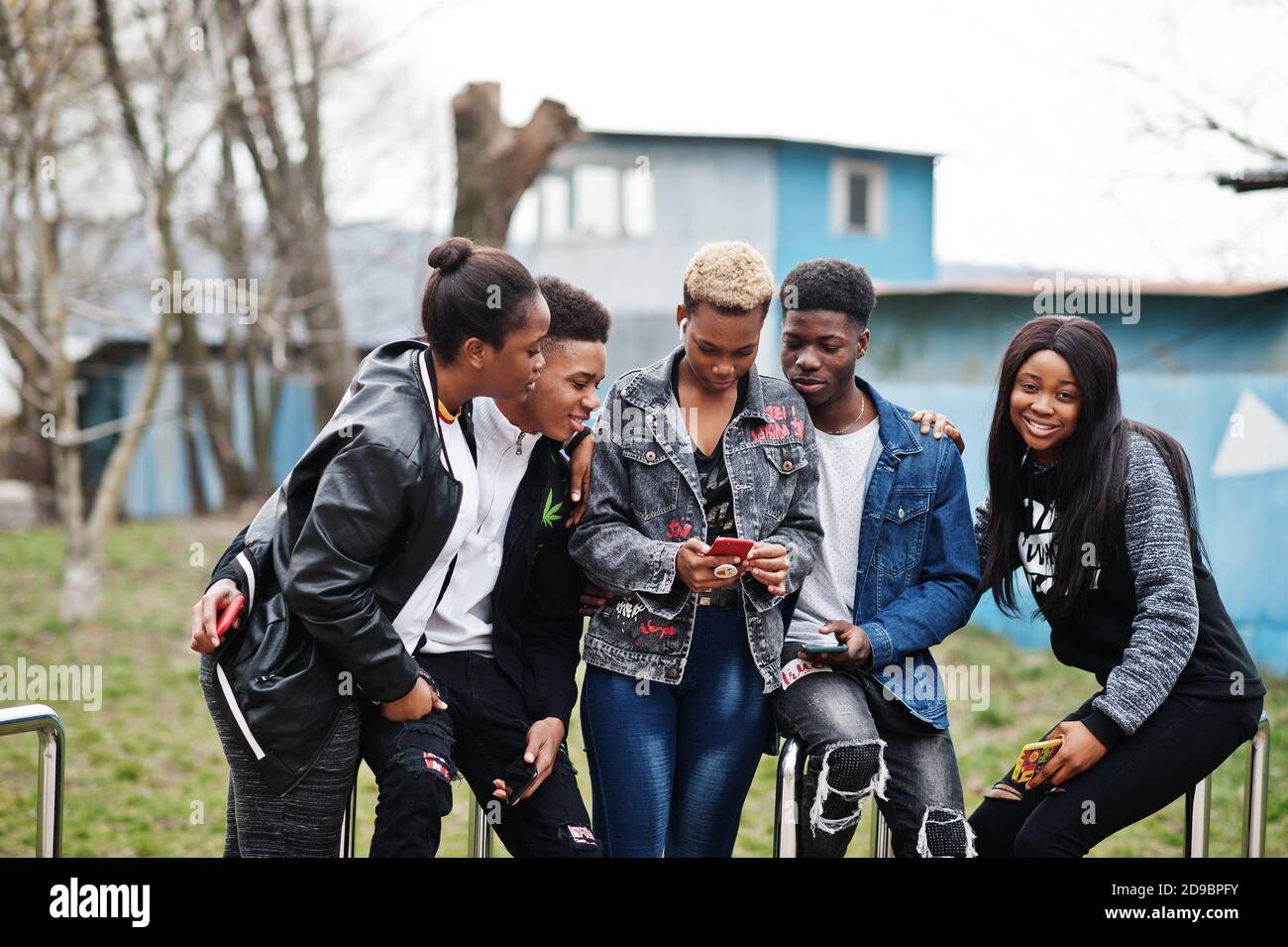 Young millennials african friends with mobile phones. Happy black ...