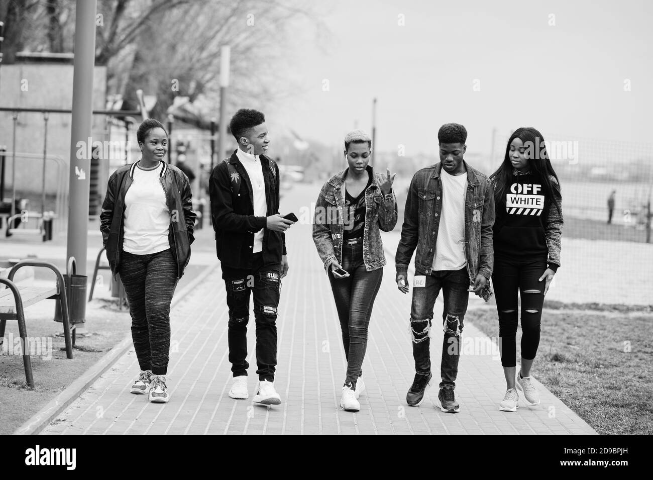 Young millennials african friends walking in city. Happy black people ...