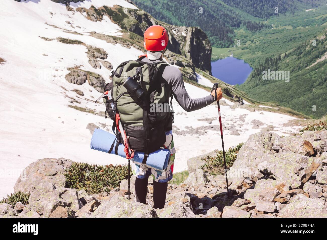 Tourist exploring mountains alone hiking with a backpack. Life on the ...