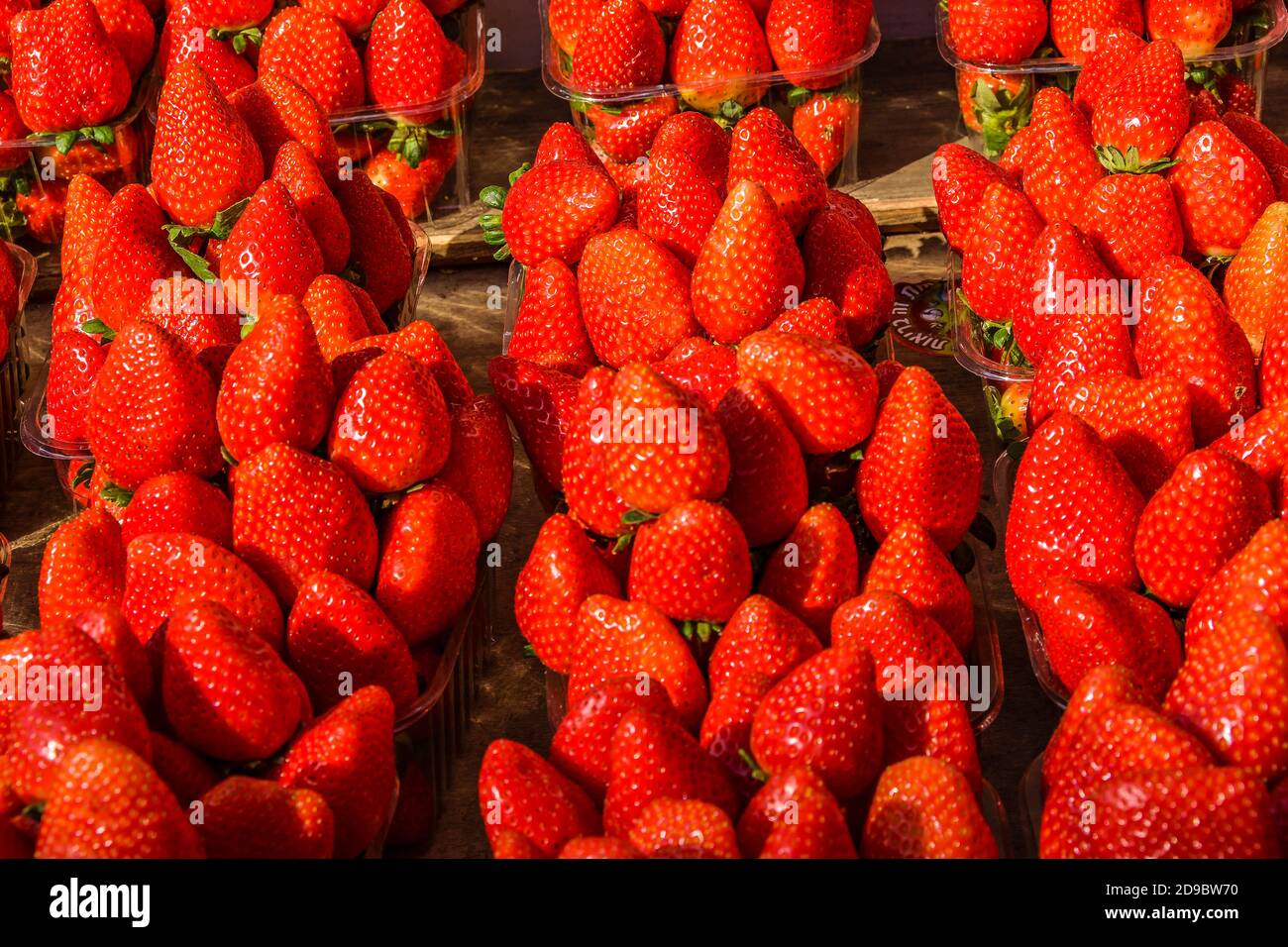 Top perspective view vivid colors strawberries at market display, tel ...