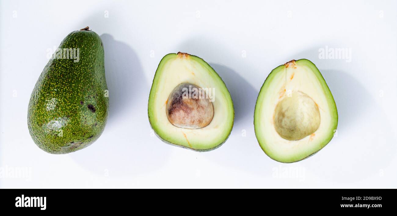 healthy food. fresh cut avocado on white background Stock Photo - Alamy