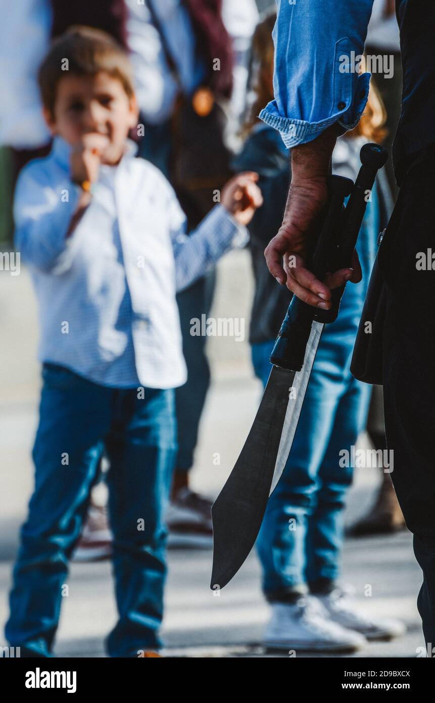 Man performs a dangerous sword juggling trick to an audience at Retiro ...