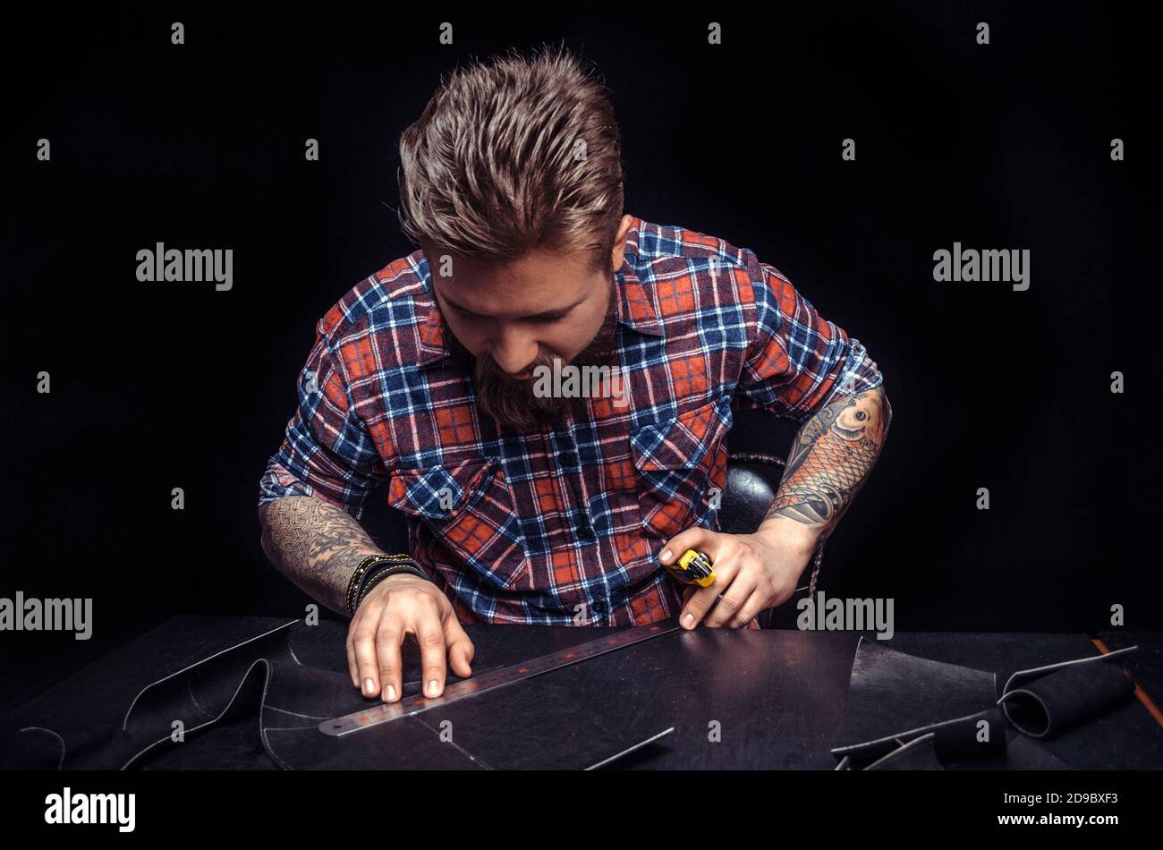 Worker of leather producing leather workpiece Stock Photo - Alamy