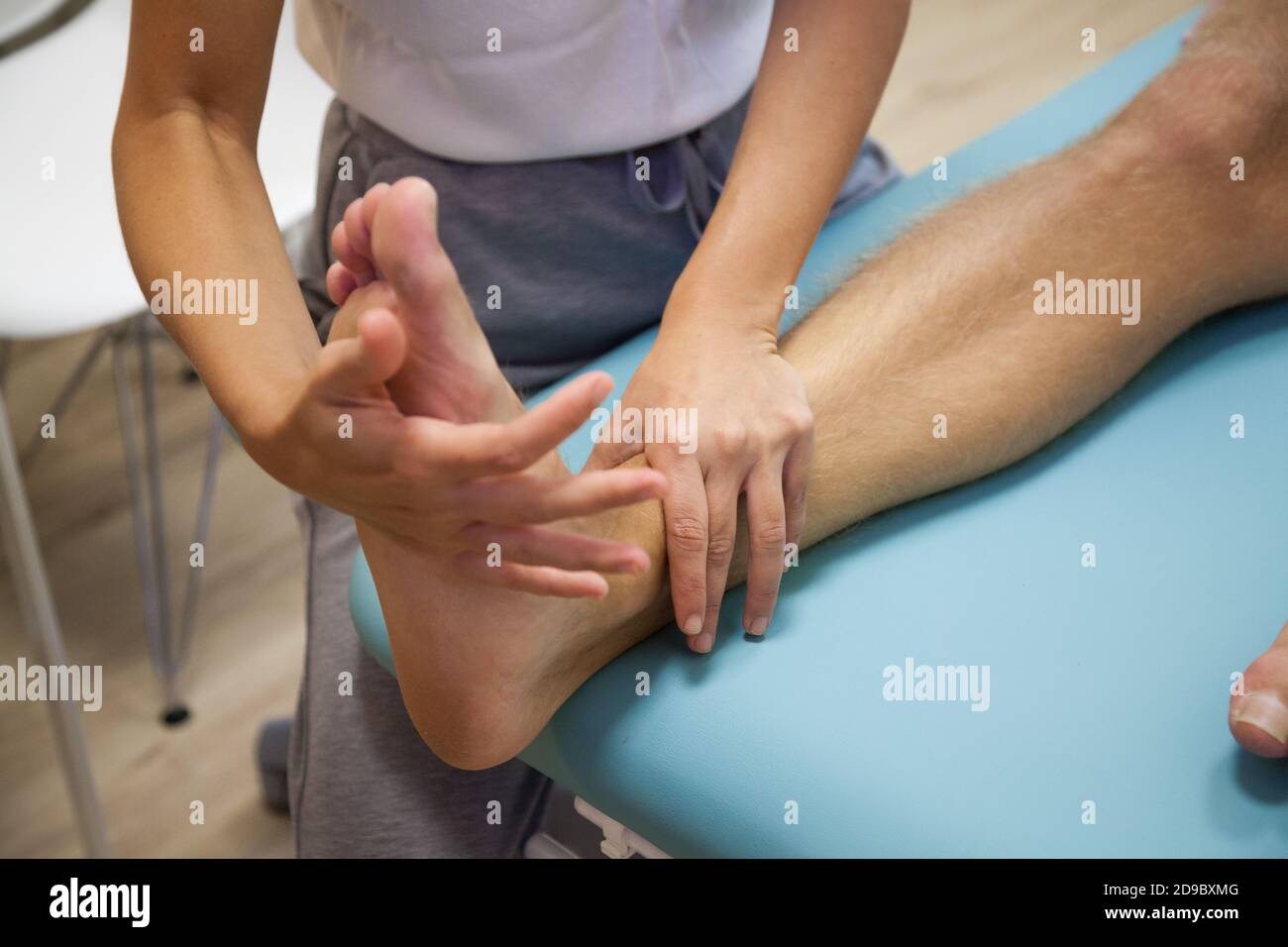 Physiotherapist consulting with patient foot problems. Physical therapy ...