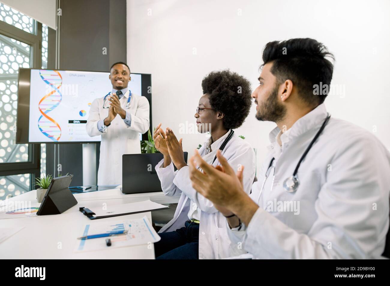 Young African male doctor giving successful speech for medical team ...