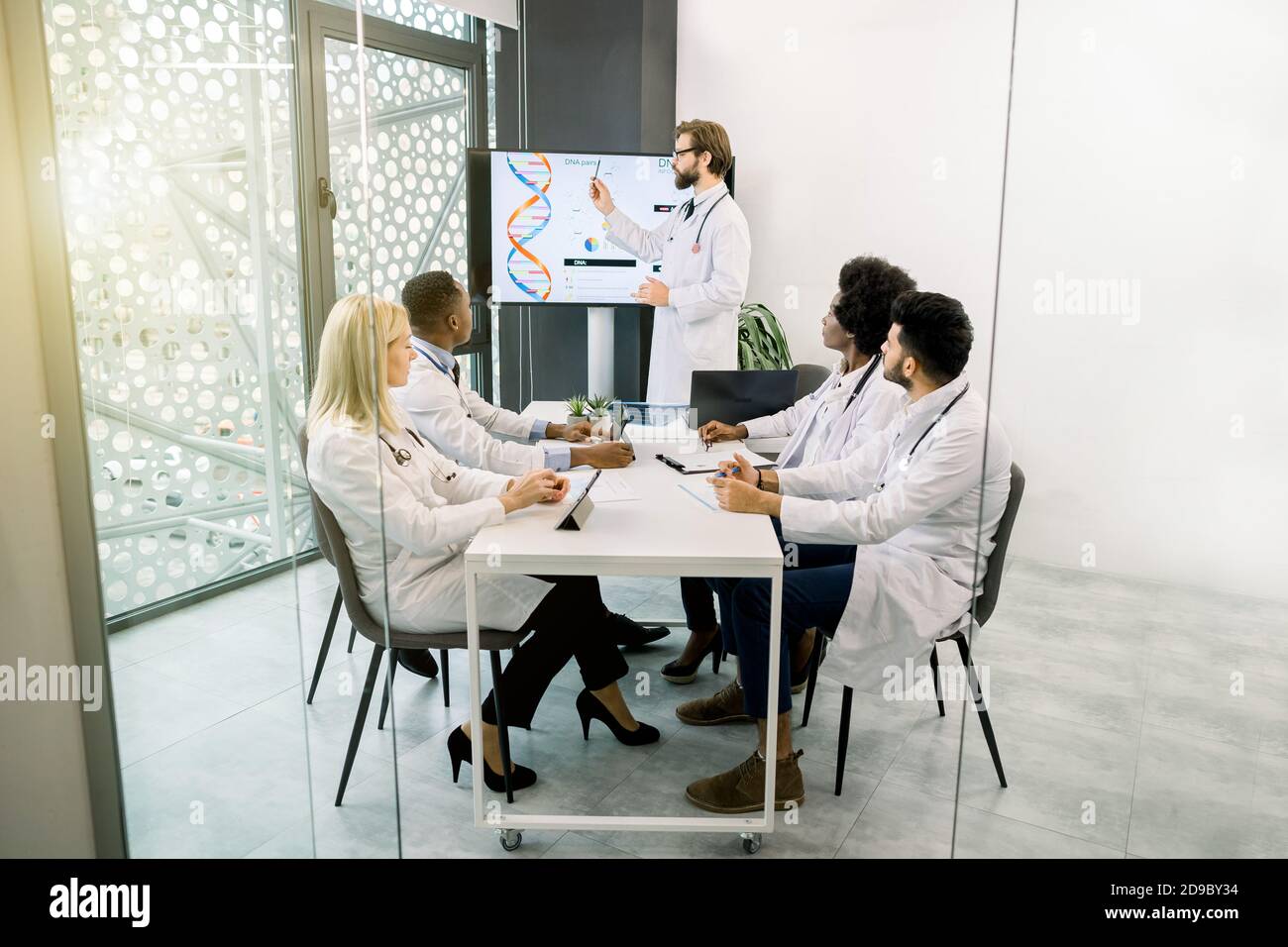 Team of international healthcare experts, looking at their young ...