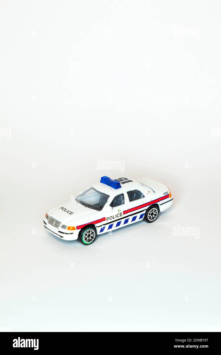 An old play worn die cast toy police car on a white background Stock ...
