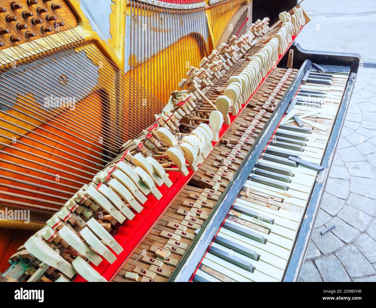 A fragment of an old broken piano with a missing wall and broken keys ...