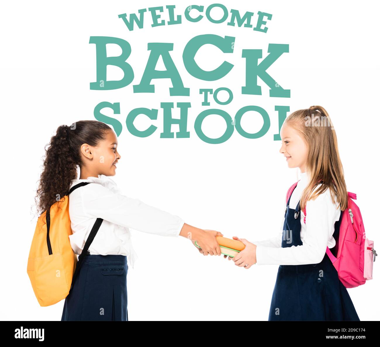 side view of african american schoolgirl giving books to smiling friend ...