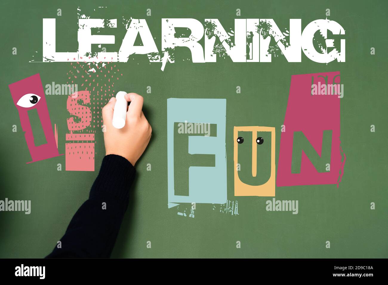 cropped view of schoolgirl writing with chalk learning is fun lettering ...