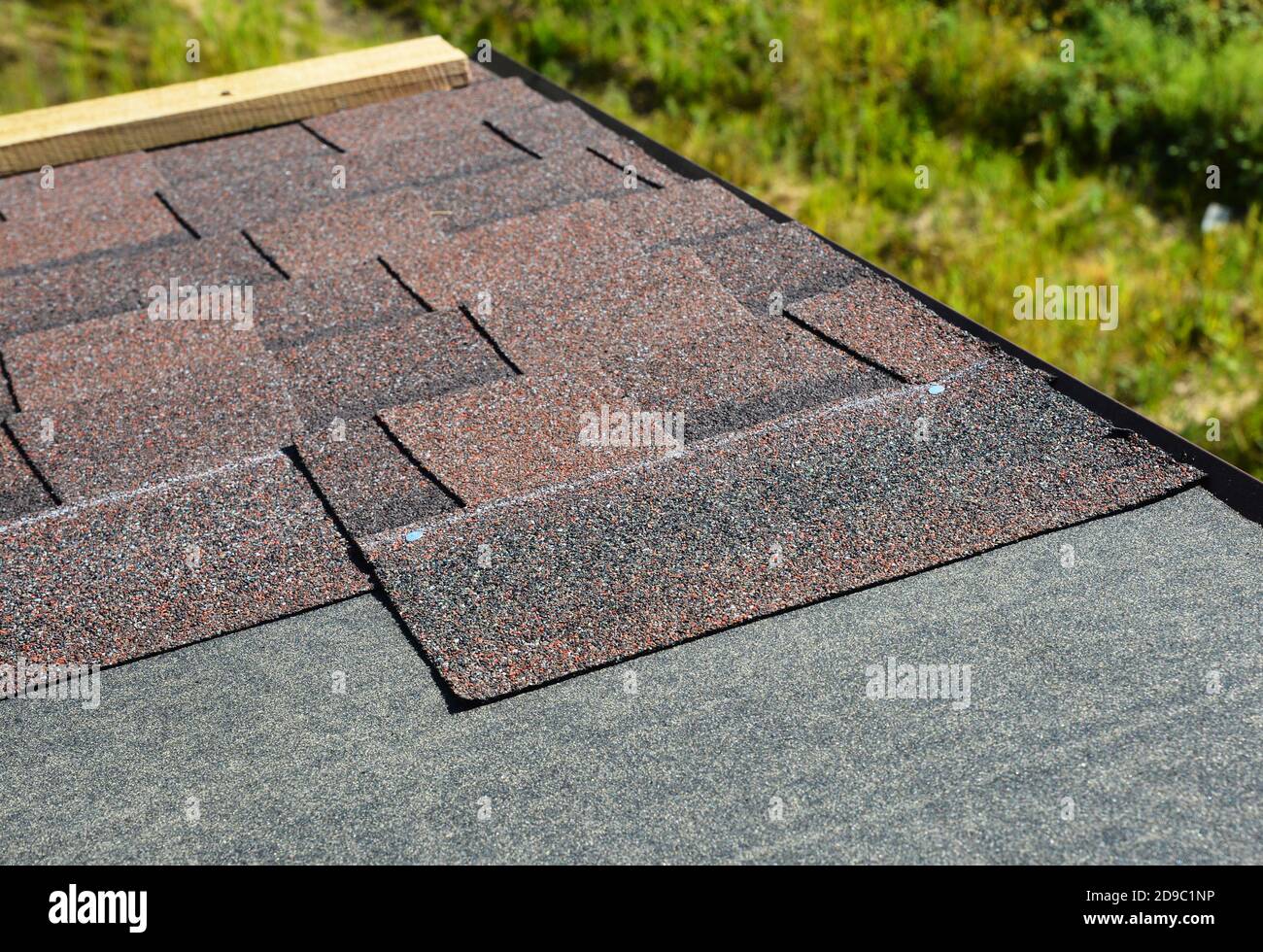 Laying asphalt shingles on house rooftop. Roofing construction concept ...