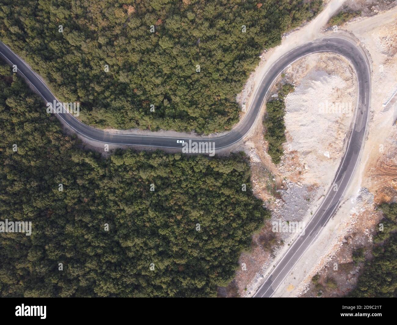 Birds Eye view of a curvy road section at countryside Stock Photo - Alamy