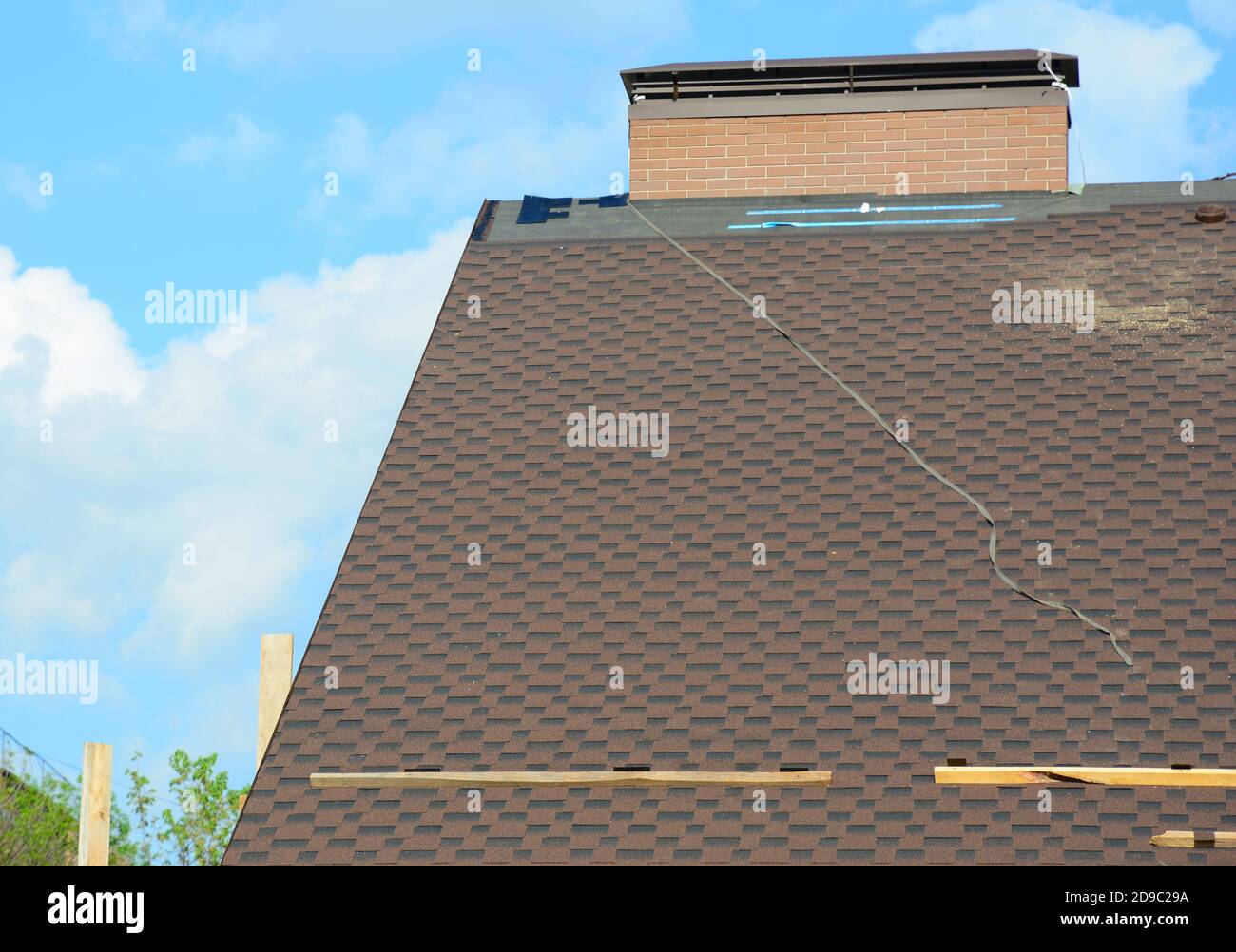 Finishing tiling, installing asphalt shingles on underlayment at the ...