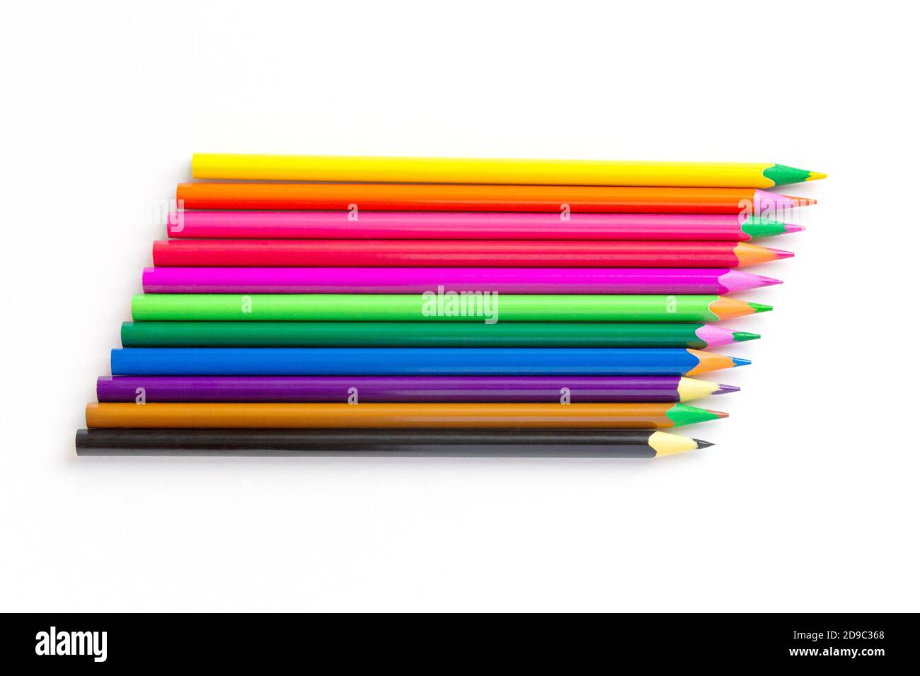 Multi-colored pencils are laid out on a white background. isolate ...