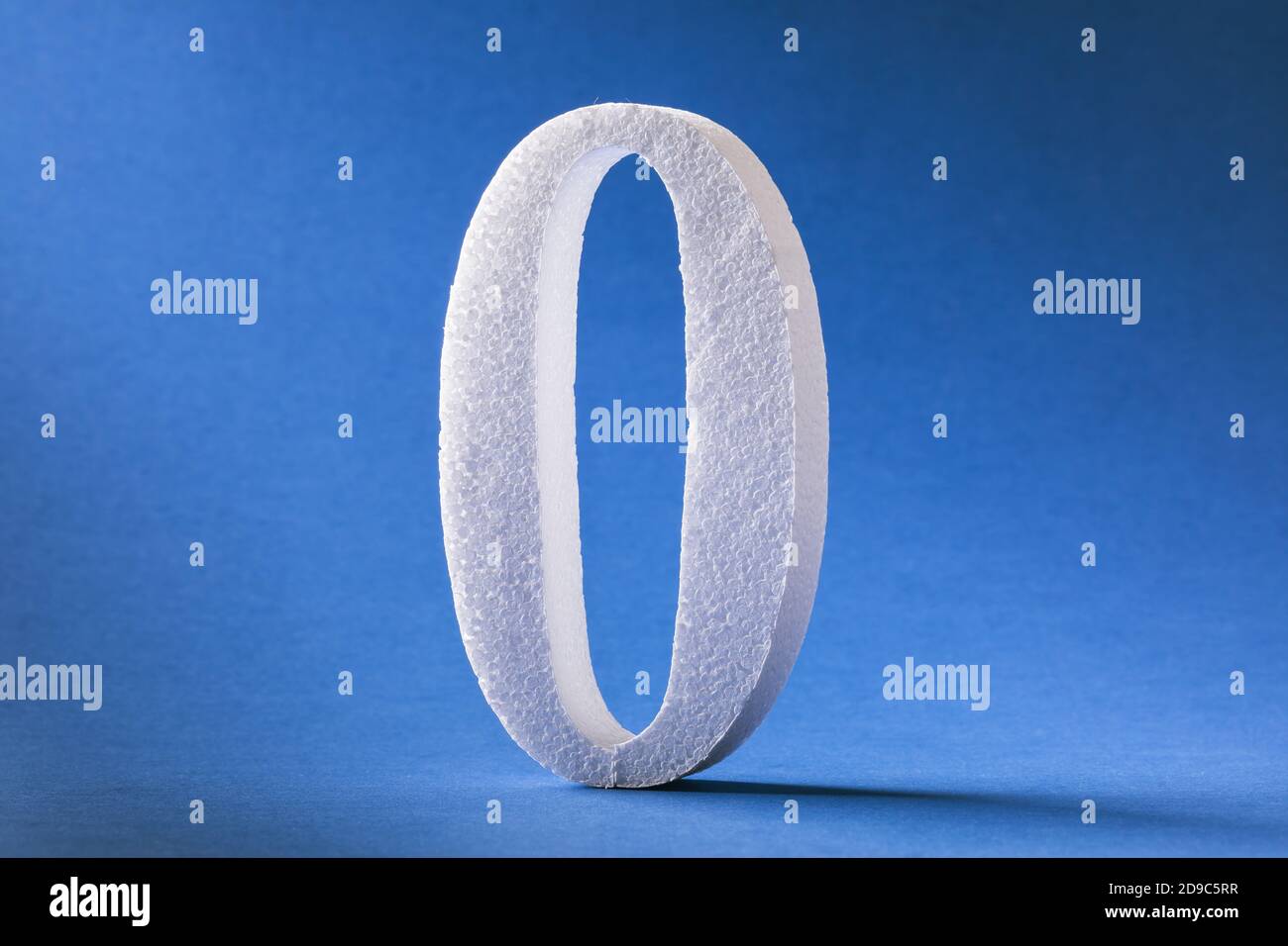 The digit is zero made of foam on a blue background. Concept on zeroing ...
