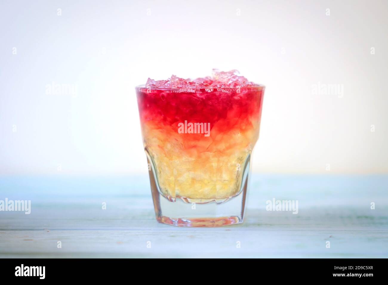 Red alcohol cocktail with vodka and cranberries and black currants ...