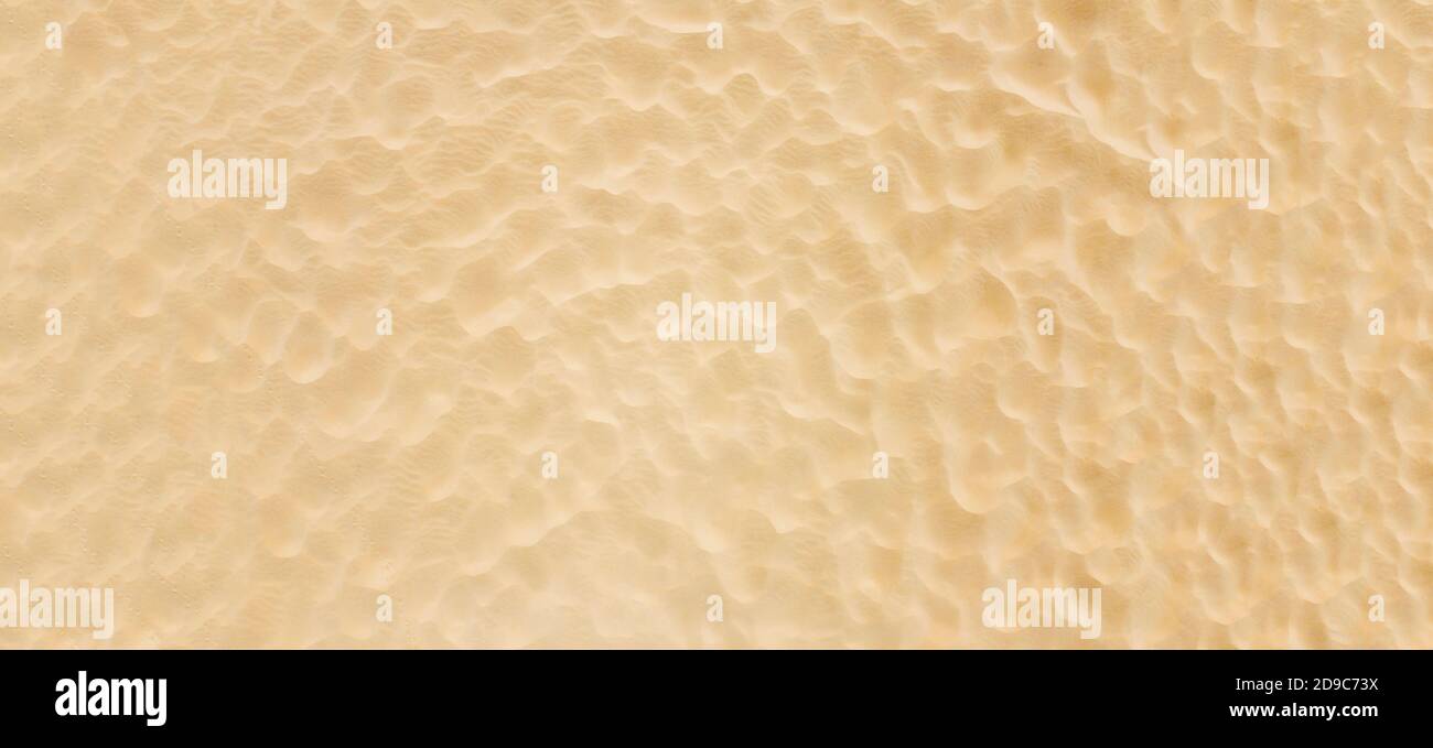 Clean sea sand on the beach, background surface texture of the coast ...