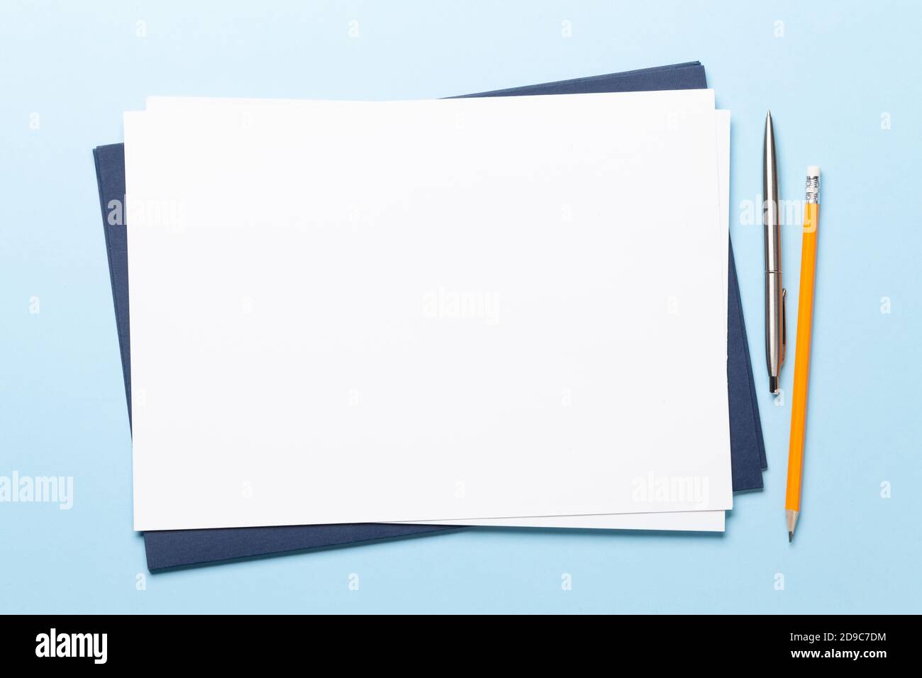 Office workplace table with blank paper page and supplies. Flat lay ...