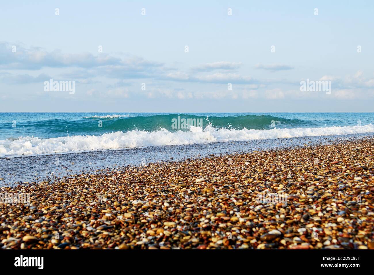 Beautiful soft sea wave on the beach with small pebbles and sand Stock ...