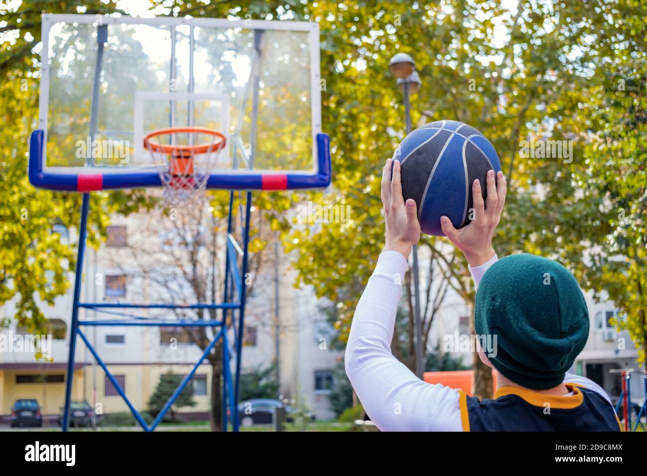 Playing basketball on outdoor court. Shooting at the hoop. Sport and ...
