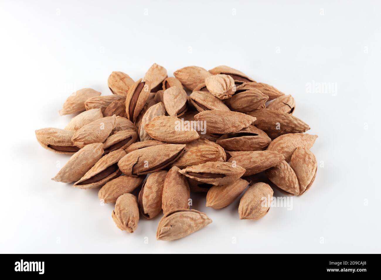 Handful of peeled almonds isolated on white background Stock Photo - Alamy