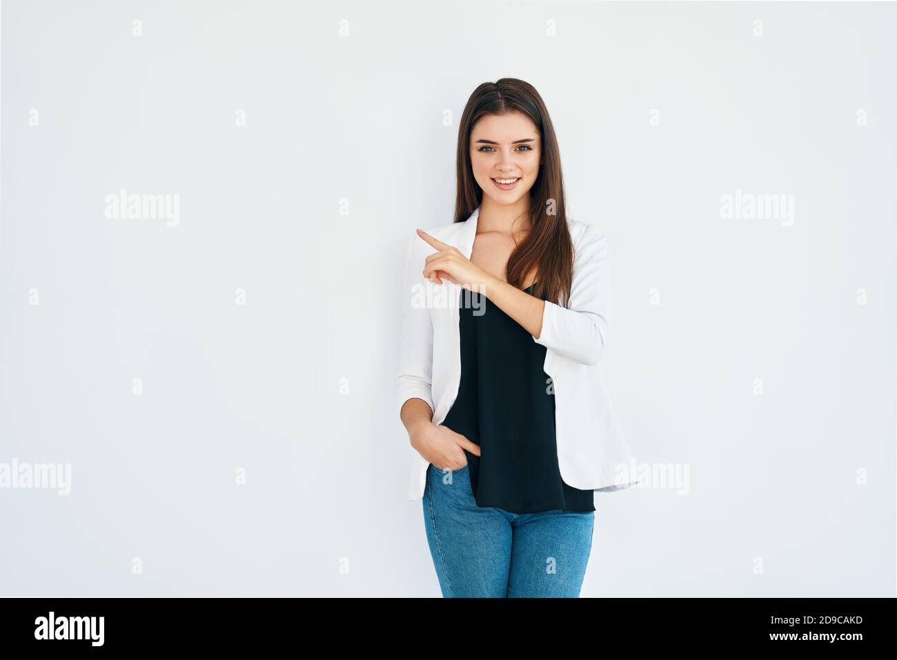 Pretty happy woman pointing her finger showing empty copy space isolated on white background ...