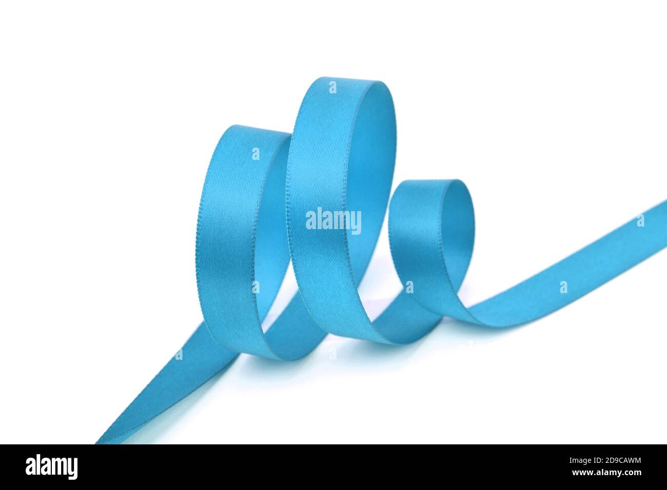 Curl of blue beautiful Satin silk holiday ribbon on a white background ...