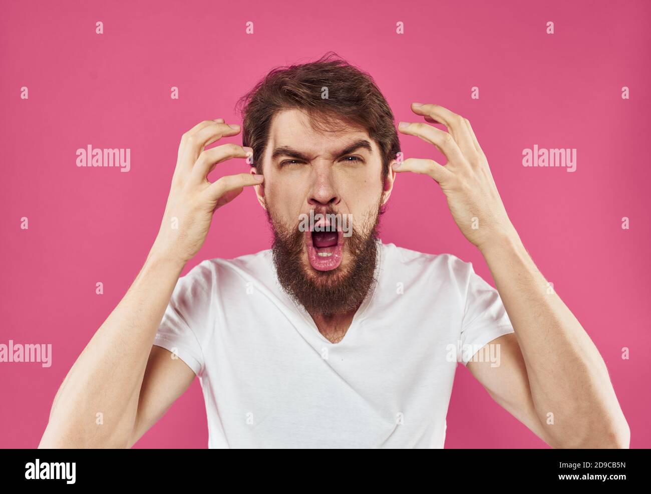 Angry man yells on pink background stress irritability model Stock ...