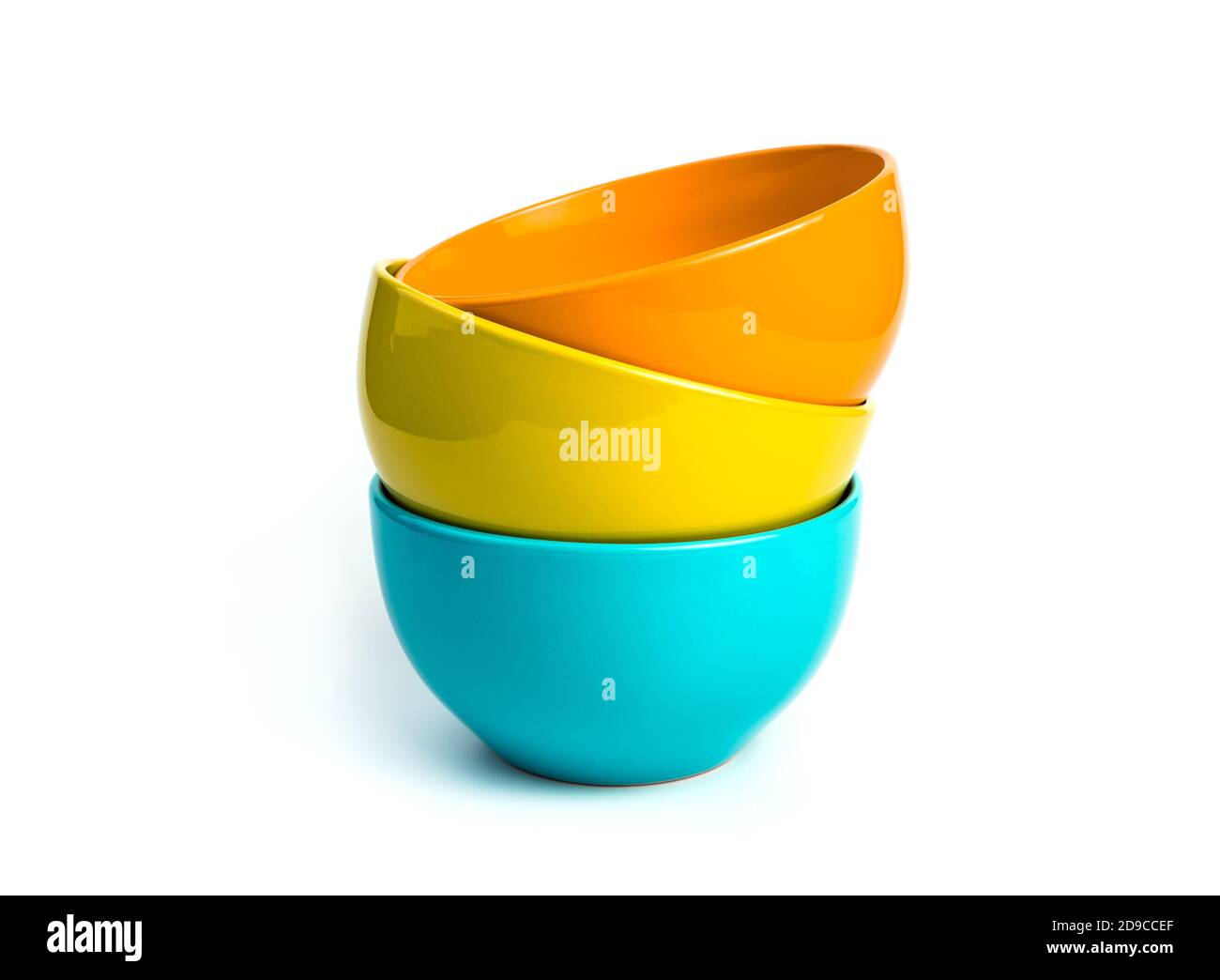 Three bowls of different colors are stacked together on a white Stock ...