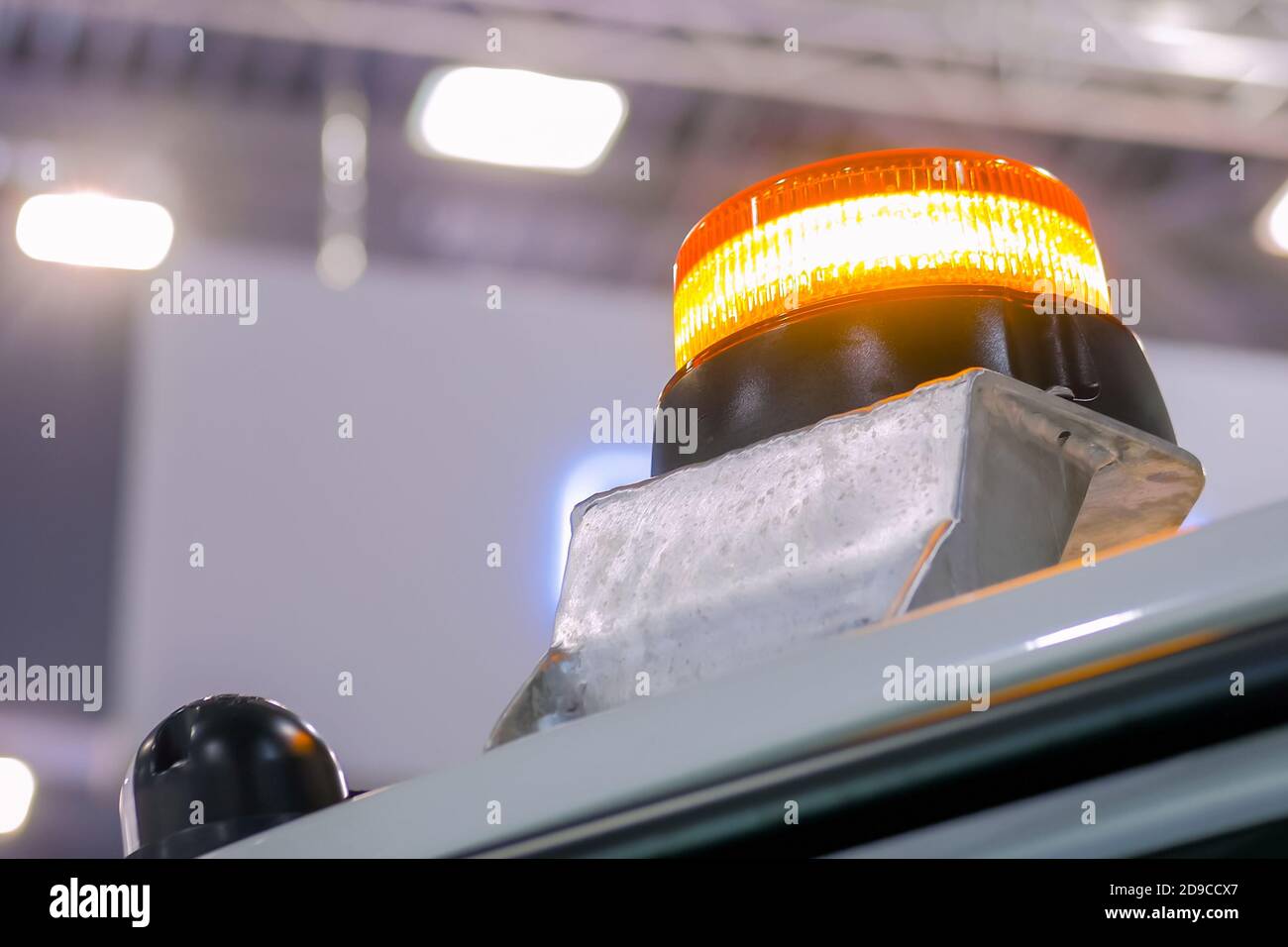 Close up of warning orange beacon flashing on roof of emergency, support and service vehicle ...