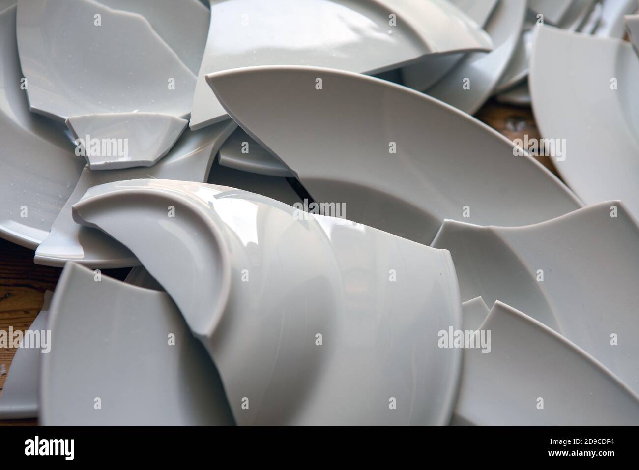 close-up of pile of broken white plates shattered on floor Stock Photo ...