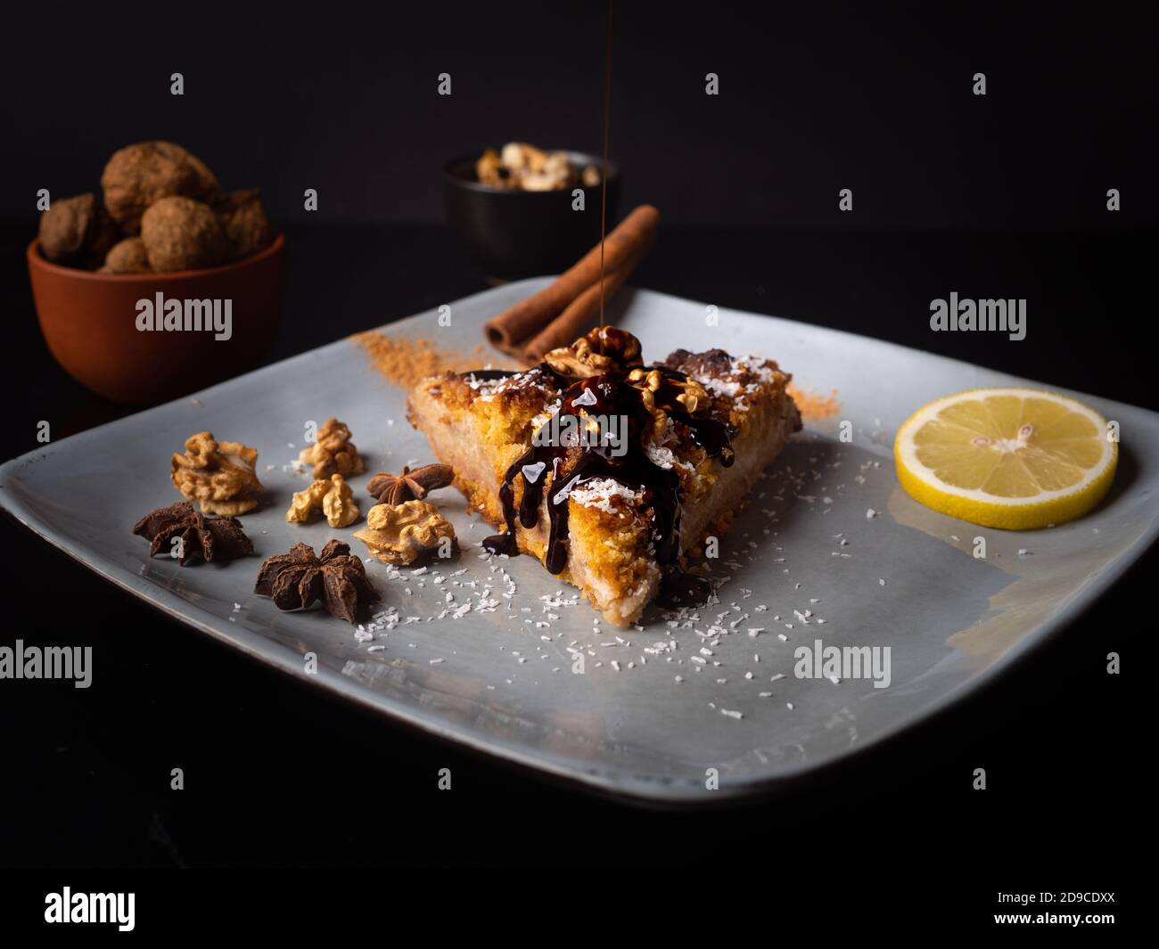 homemade apple pie on plates with lemon garnish on a black background ...