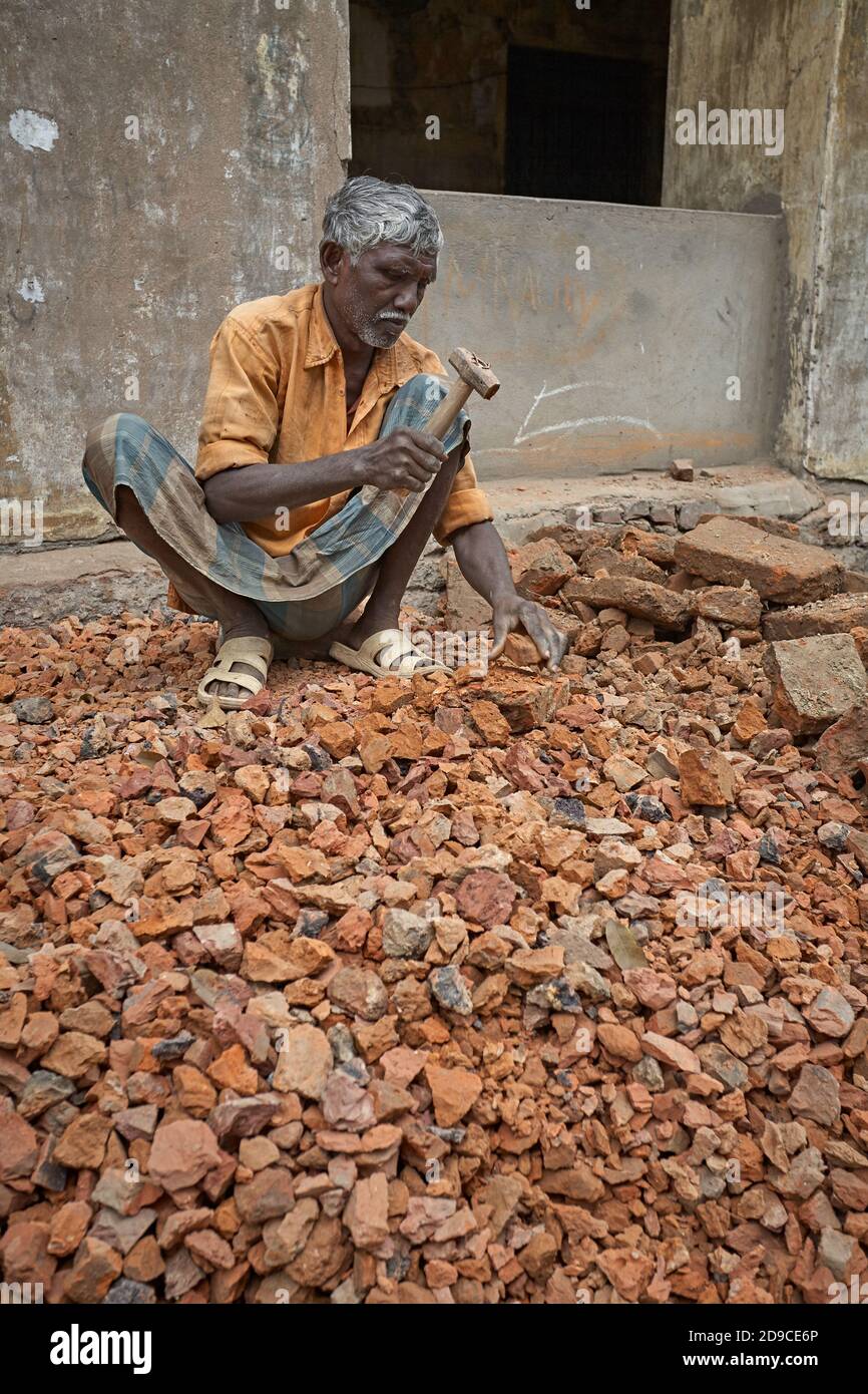 Kolkata, India, January 2008. Worker breaking bricks with a hammer for ...