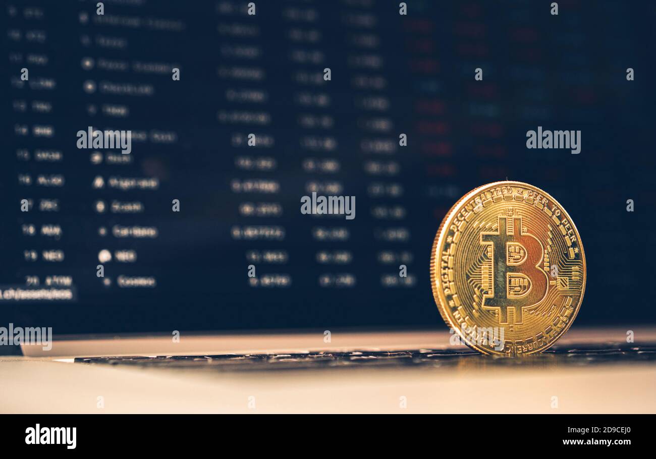 Golden Bitcoin Metal Symbolic Coin on Computer Keyboard. Trading Data ...