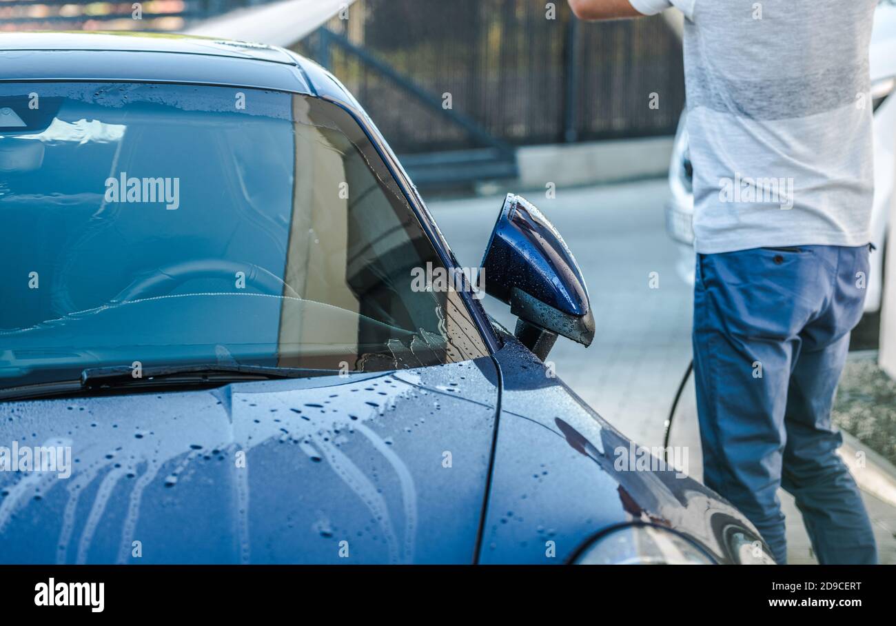 Caucasian Men Washing His Blue Sporty Looking Car on His Driveway. Car ...