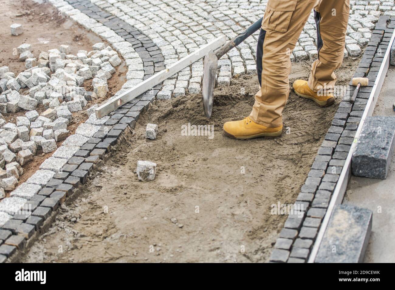 Construction Contractor Worker Paving Residential Path Using Granite ...