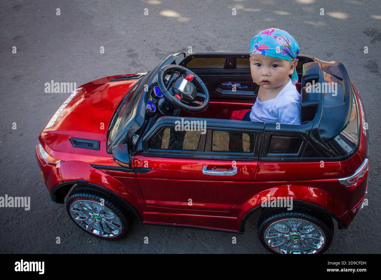 Child in a toy car in Mongolia Stock Photo - Alamy