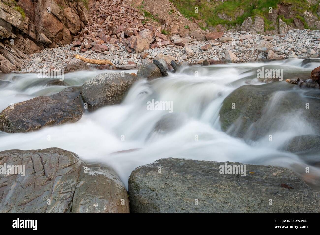 Long exposure of the river Heddon flowing onto the beach at Heddons ...