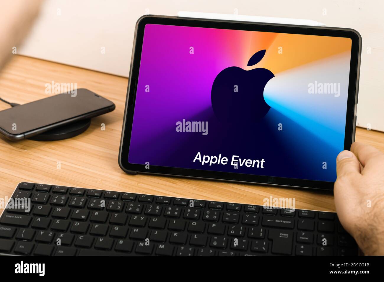 Apple Event Logo on the tablet screen. Man watching presentation from ...
