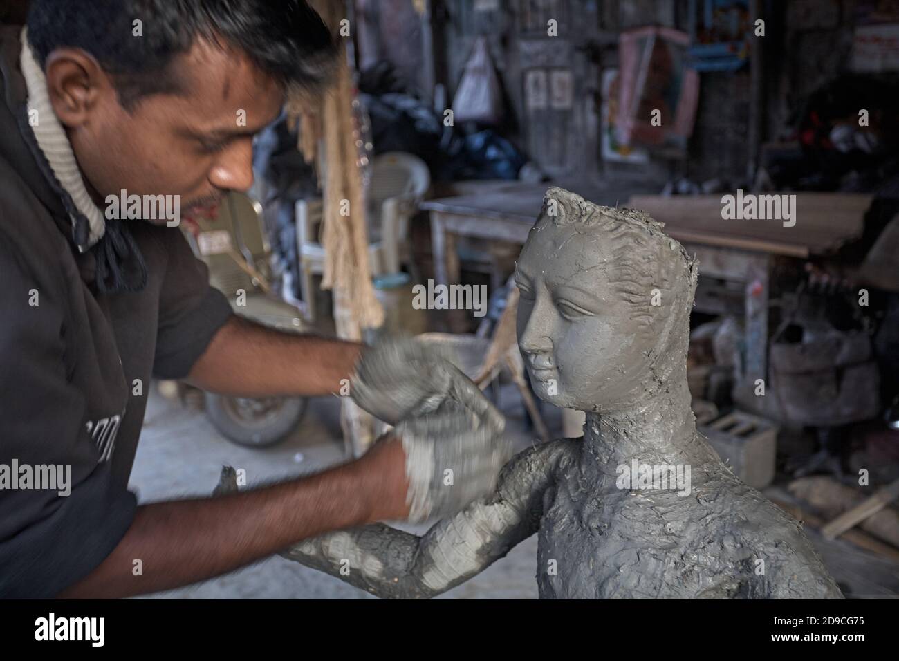 Kolkata, India, January 2008. Modeler of figures for the puja in his ...