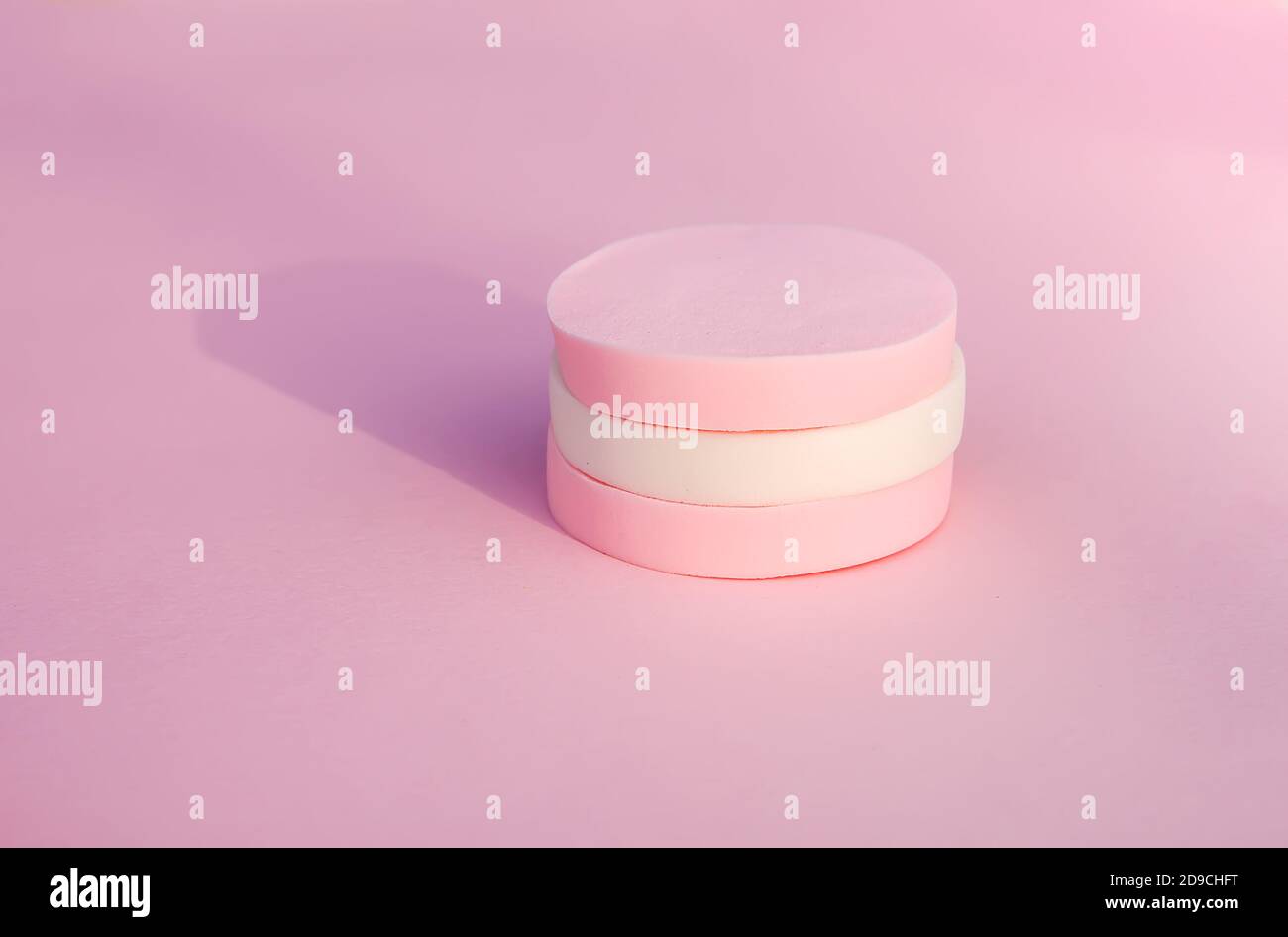 Cosmetic sponges in pastel colors on soft pink background Stock Photo ...