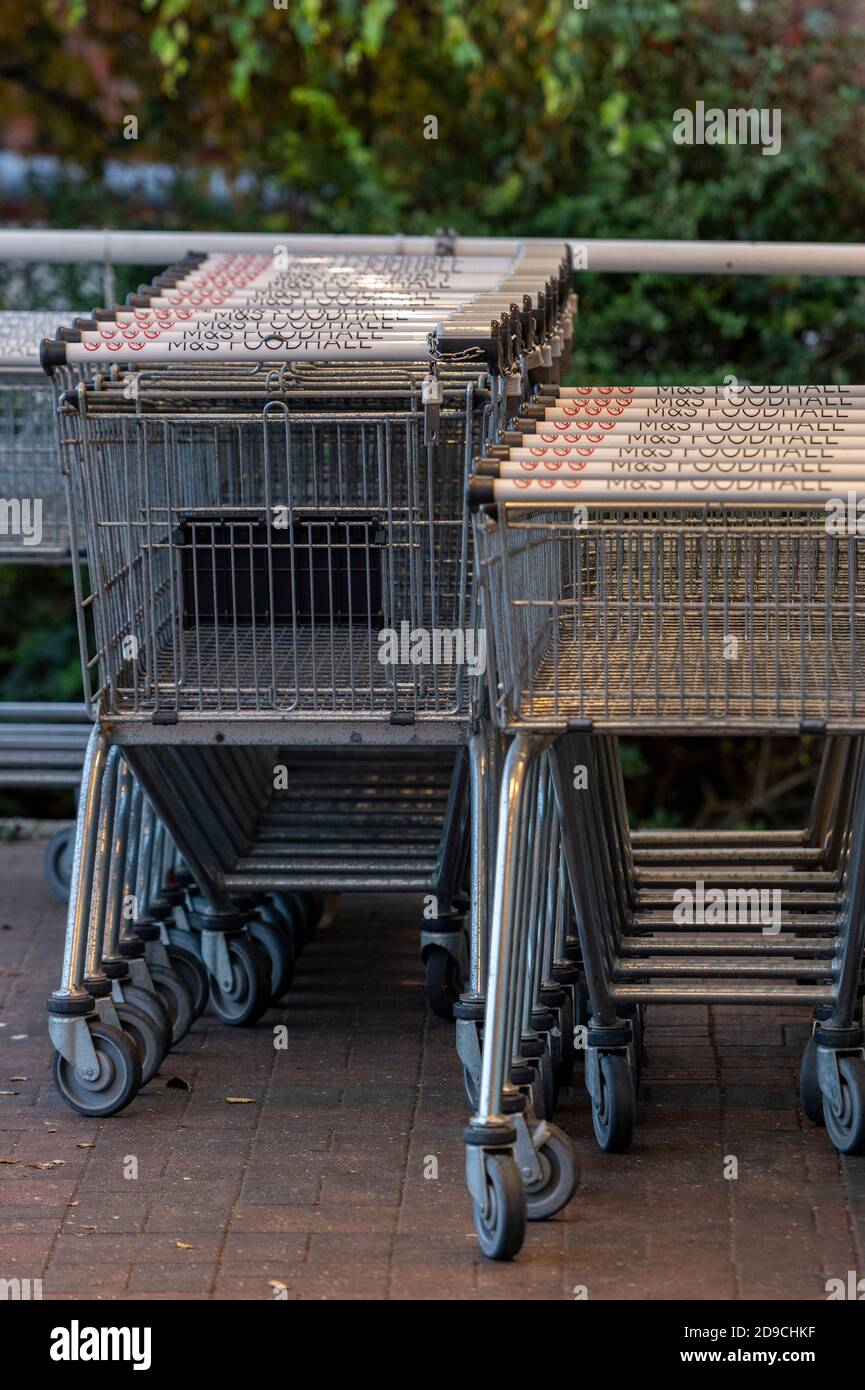 shopping trolley in rows and stacked outside of a supermarket waiting ...