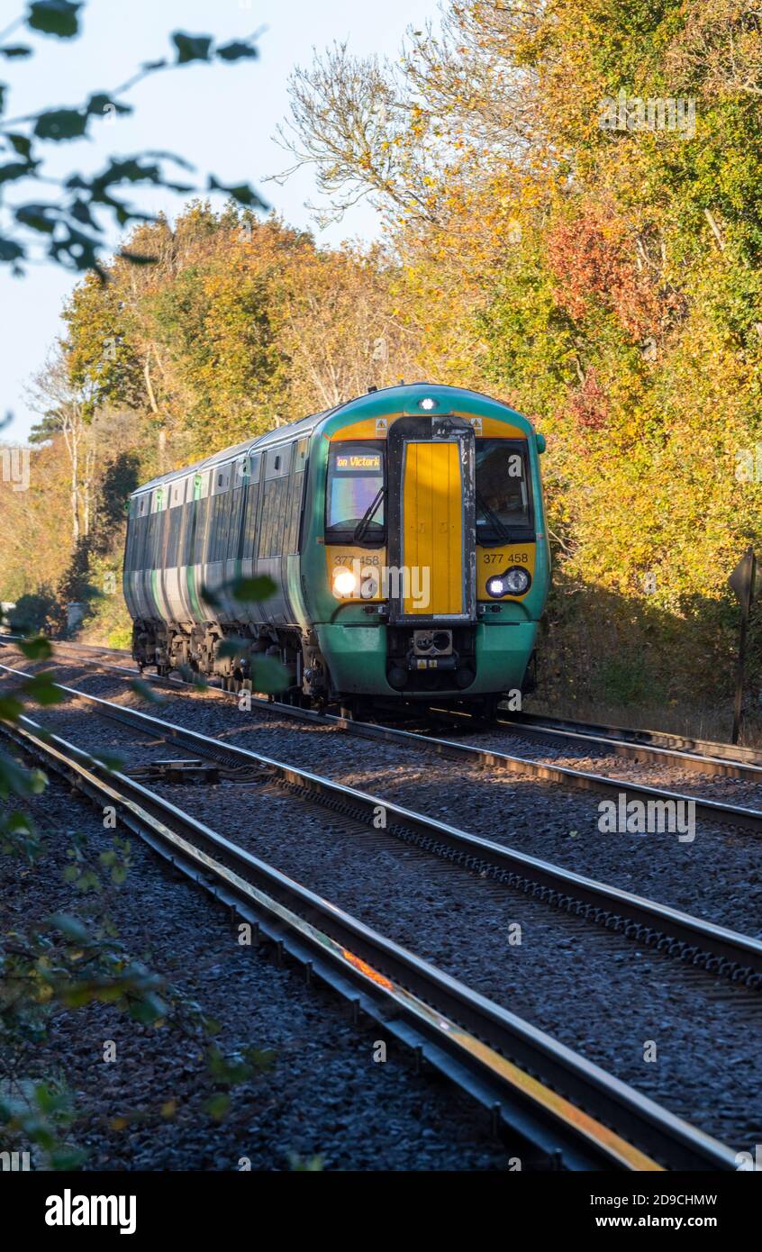a southern railways train service on a track during the autumn leaf ...